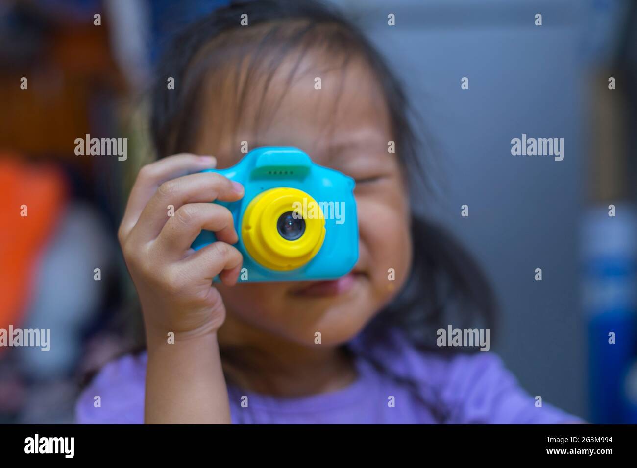 taking pictures of others. Little girl taking picture using toy camera ...