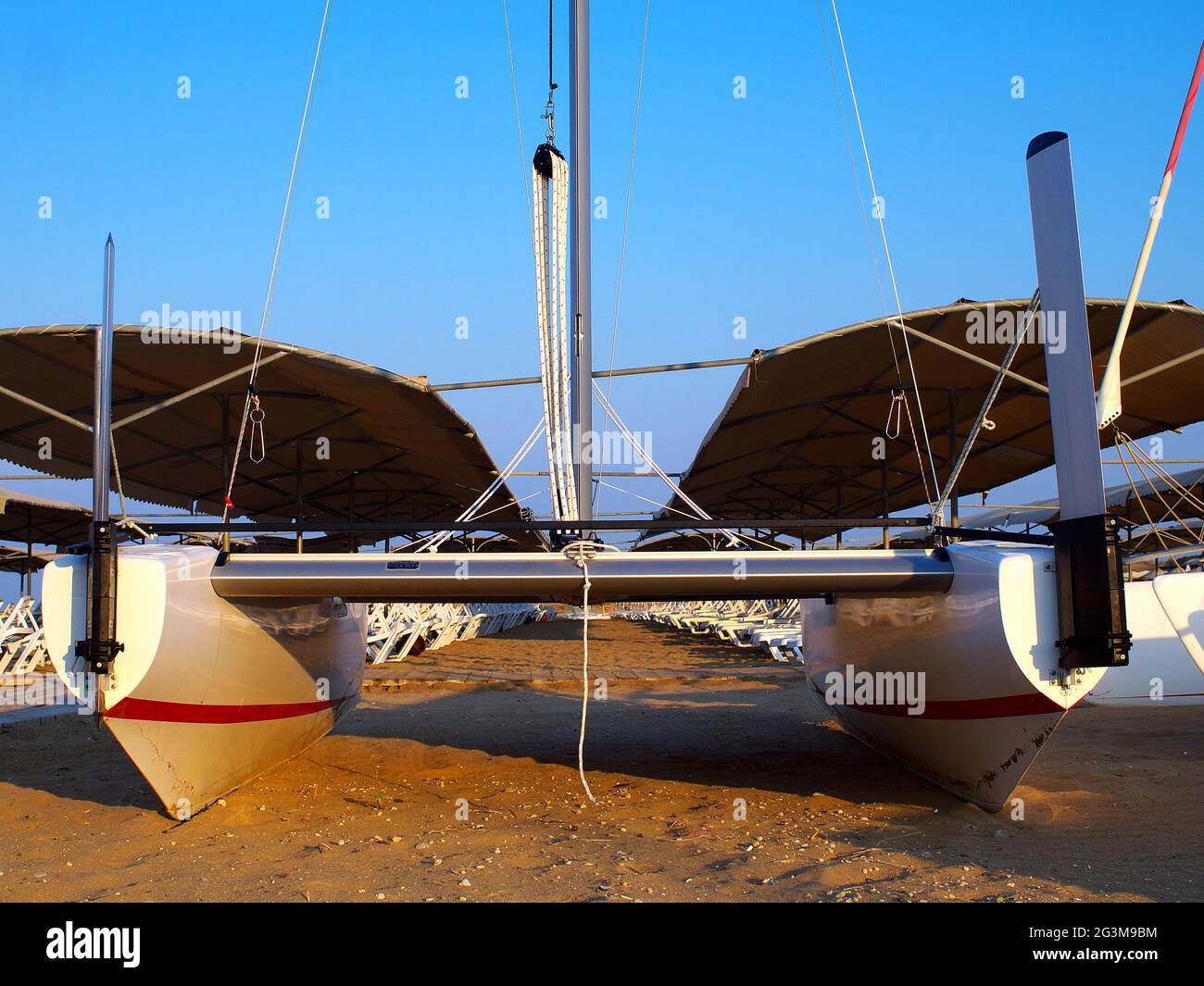 catamaran sailing boat parked on beach early in the morning under ...