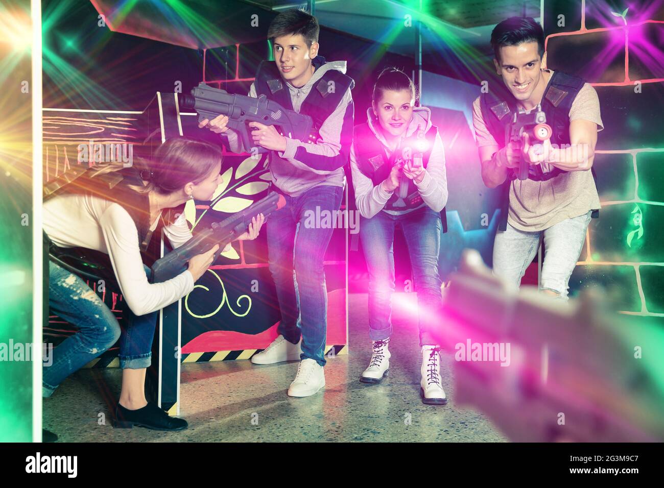 Young people playing laser tag Stock Photo - Alamy