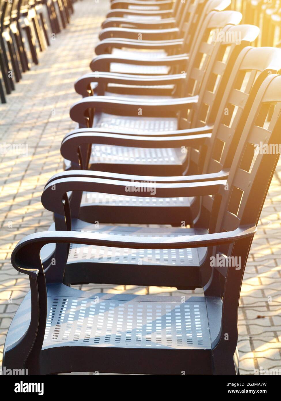 row of empty chairs outdoor before concert or show, toned, sunlight ...