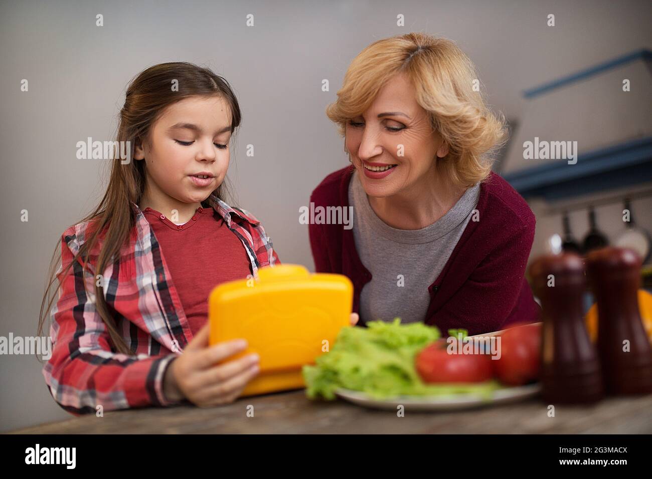 Beautiful grandma and granddaughter are making sandwiches Stock Photo ...