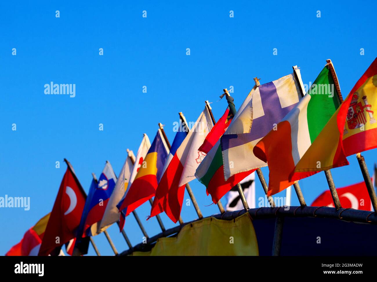 various flags in a row against blue sky Stock Photo - Alamy