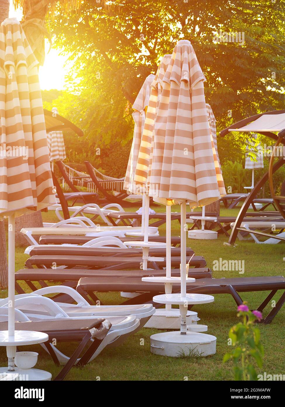 Folded umbrellas sunbeds in hi-res stock photography and images - Alamy
