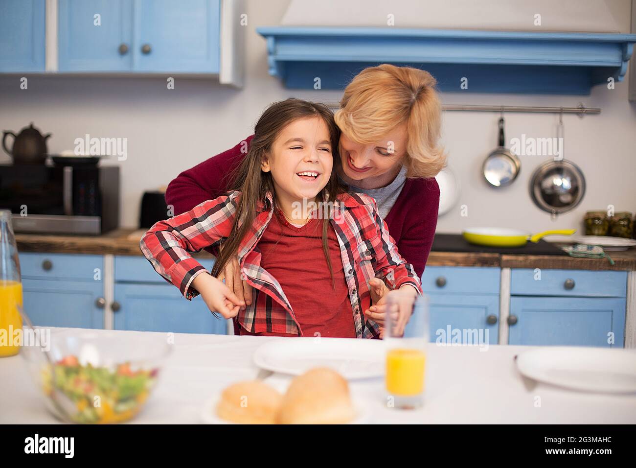 Grandmother and granddaughter lay the table Stock Photo - Alamy