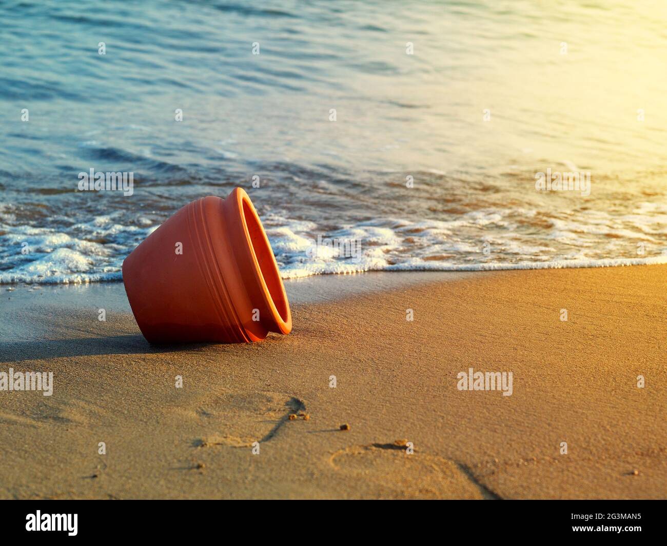 clay pot on a sand beach, evening, sunset Stock Photo - Alamy