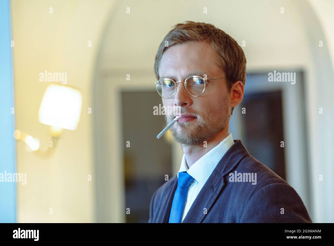 Businessman smoking cigarette Stock Photo - Alamy