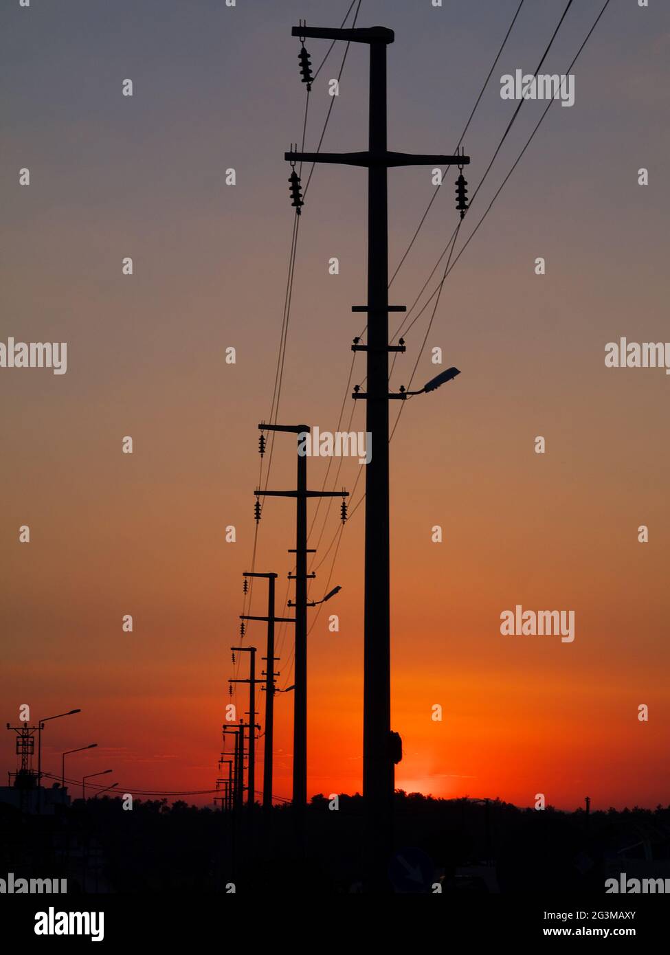 road with power line and lamp posts in sunset Stock Photo - Alamy