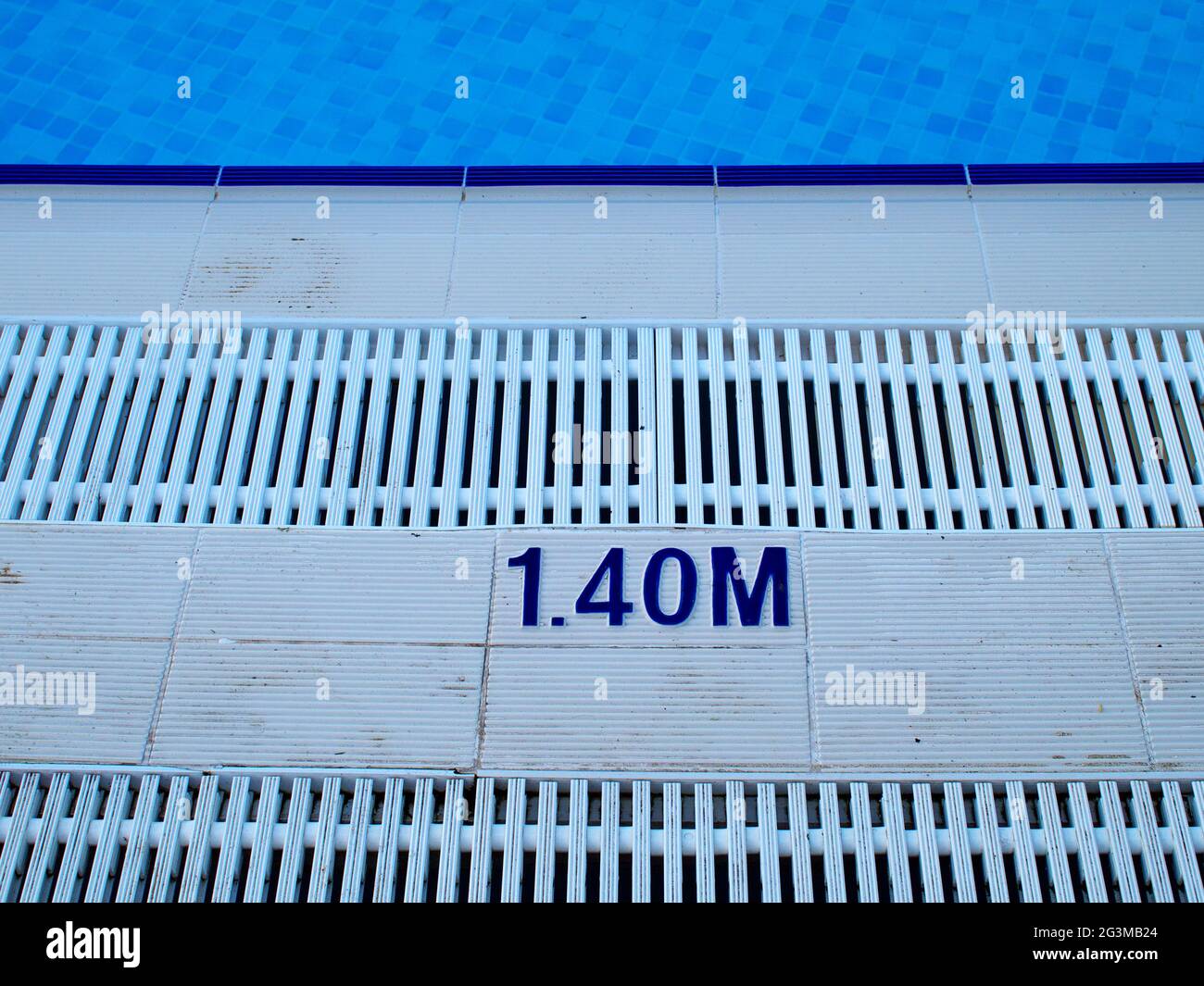 swimming pool depth marker and overflow grating Stock Photo - Alamy