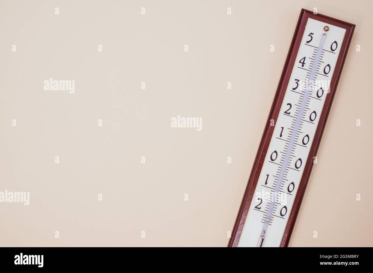 Closeup of a room thermometer isolated on the light beige background on ...