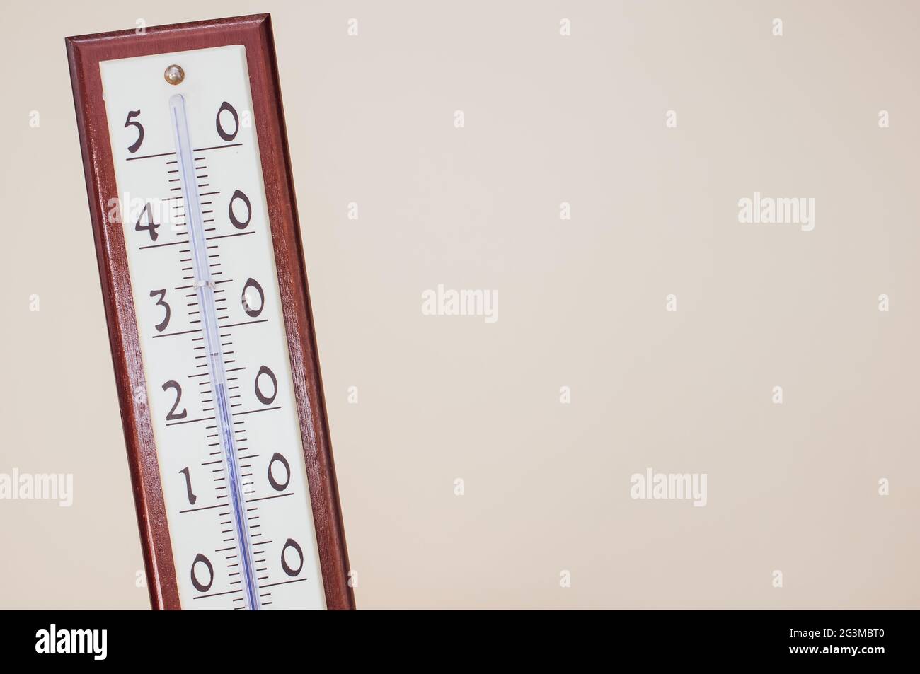 Closeup of a room thermometer isolated on the light beige background on ...