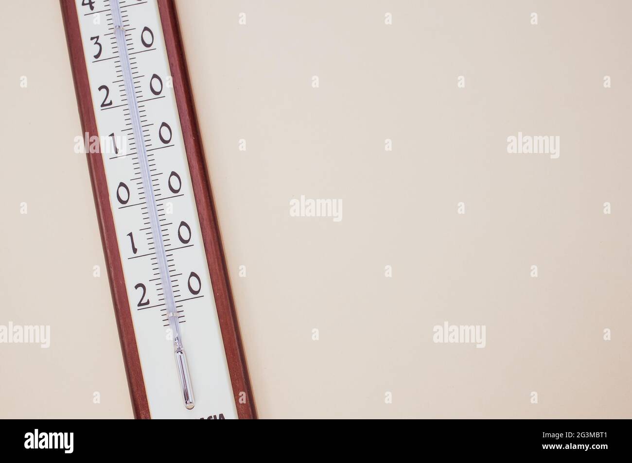 Closeup of a room thermometer isolated on the light beige background on ...