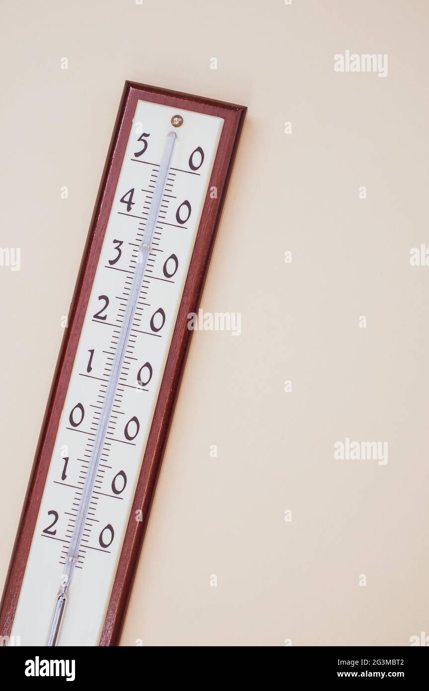 Vertical shot of a room thermometer isolated on the light beige ...