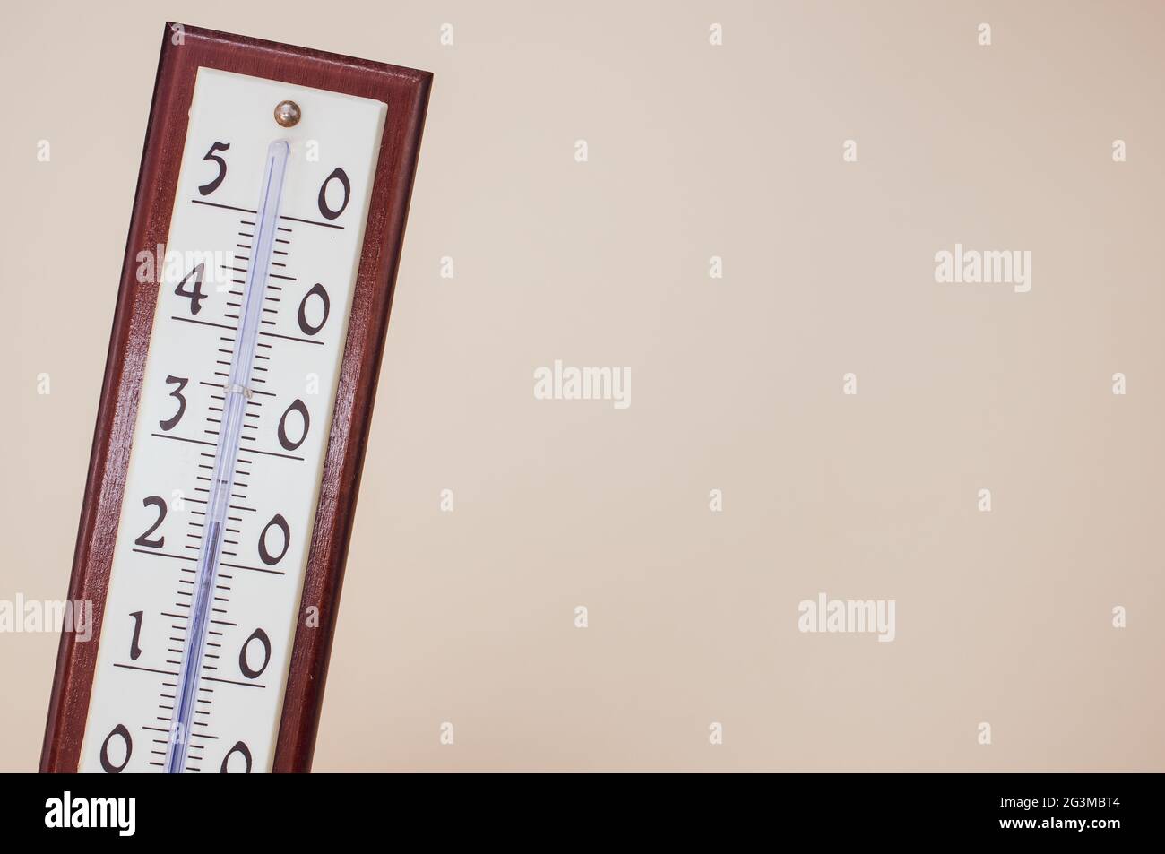 Closeup of a room thermometer isolated on the light beige background on ...