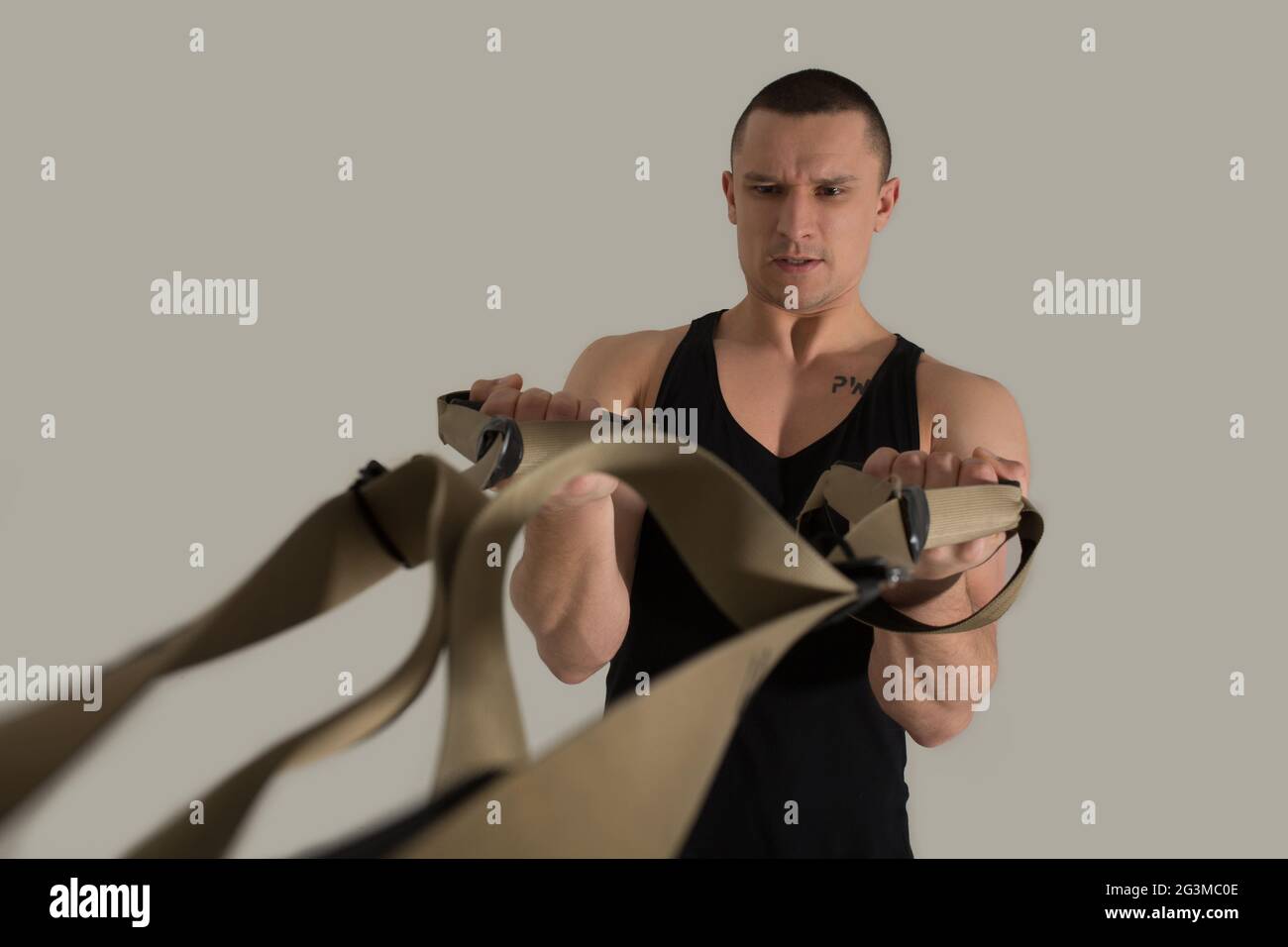 Arms muscles training on TRX bodybuilder Stock Photo - Alamy