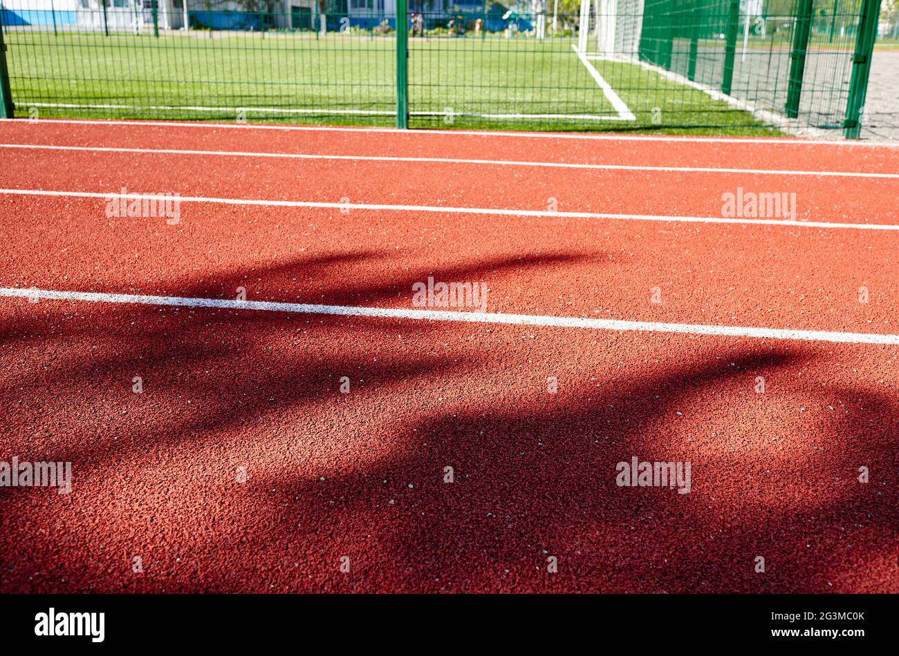 Red treadmill on sport field. Running track on the stadium Stock Photo ...