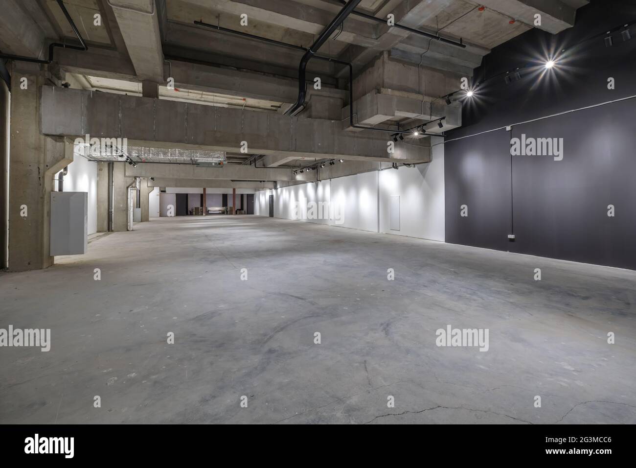 empty interior of large concrete room as warehouse or hangar with ...