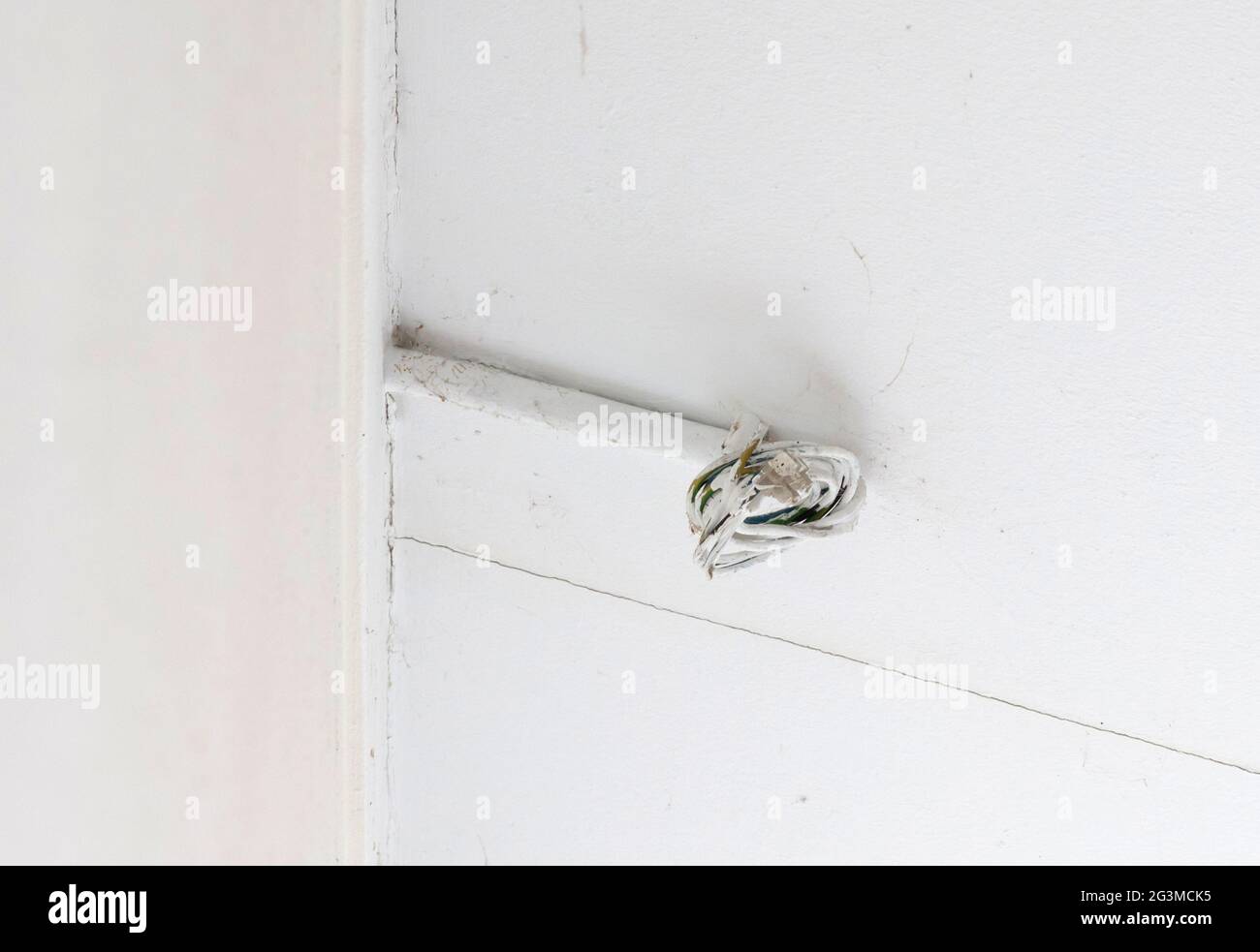 Wires hanging on a ceiling Stock Photo - Alamy