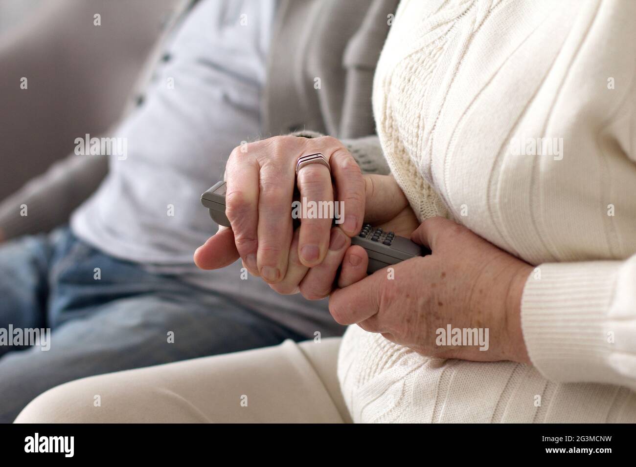 Old lady holding TV remote Stock Photo - Alamy