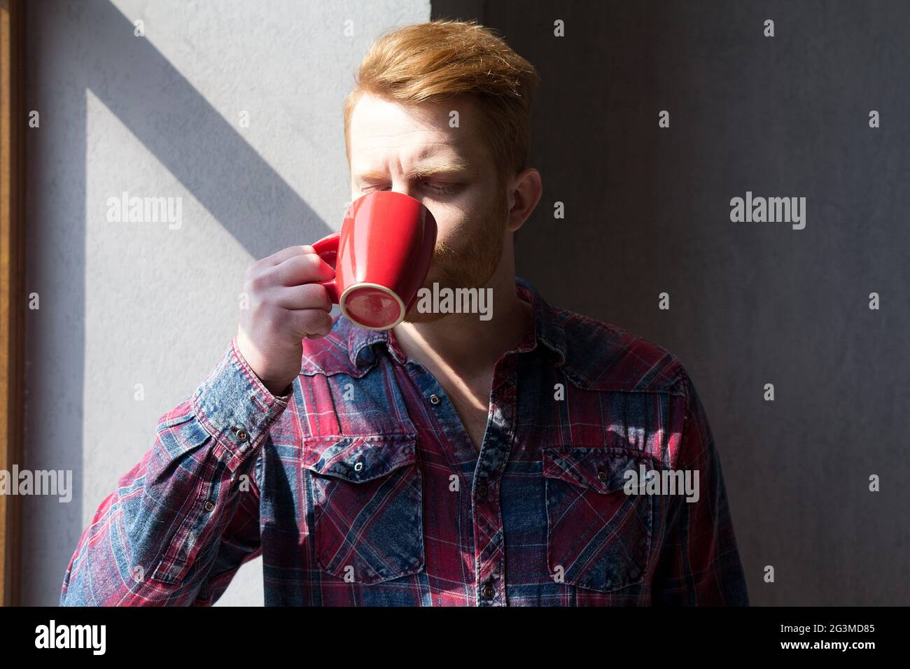Attractive guy drinking coffee Stock Photo - Alamy