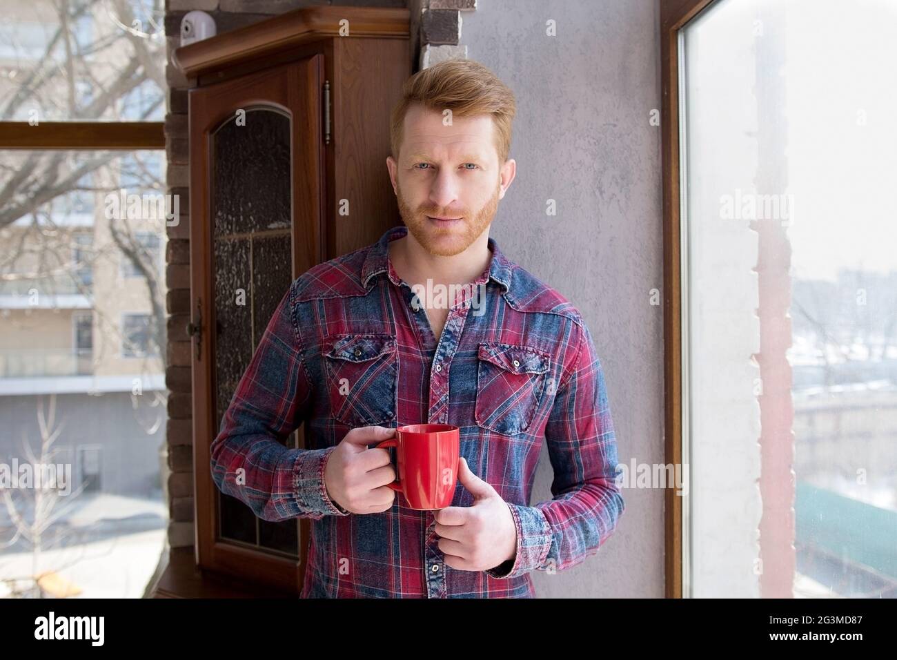 Attractive guy drinking coffee Stock Photo - Alamy