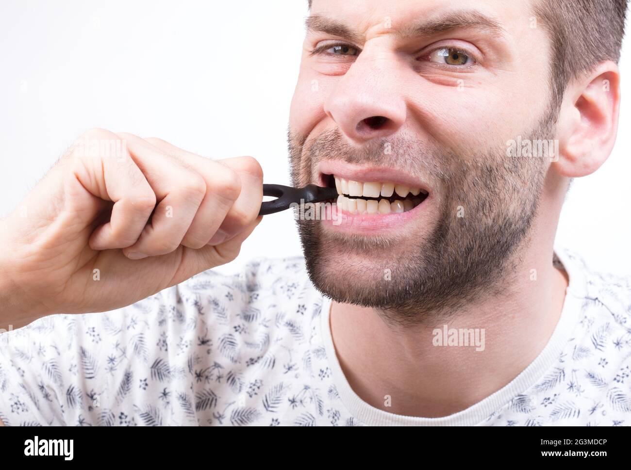 Man eating typicaly dutch candy called 'Dropsleutel' (candy key Stock ...
