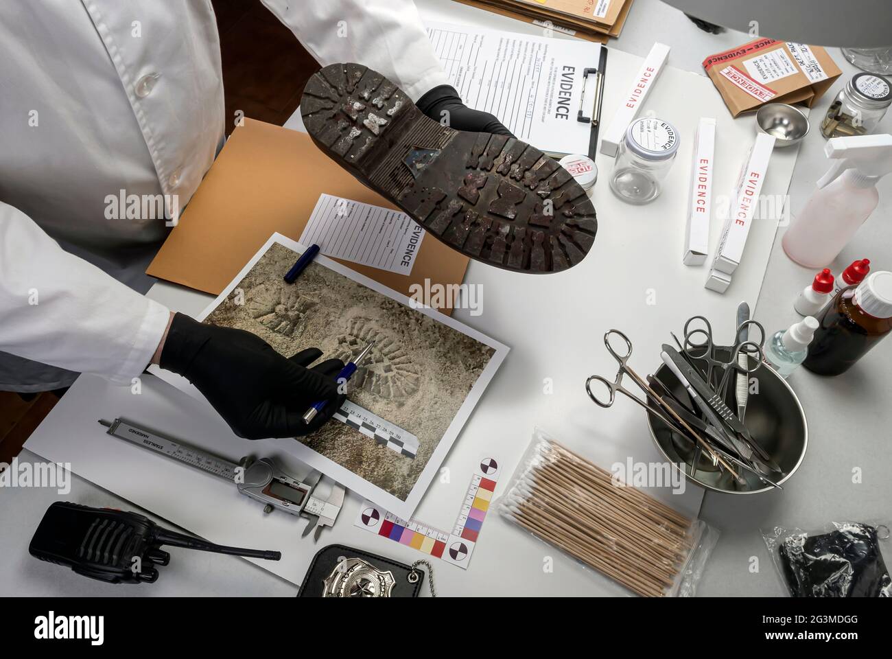 Forensic scientist investigates shoeprint mould evidence in crime lab ...