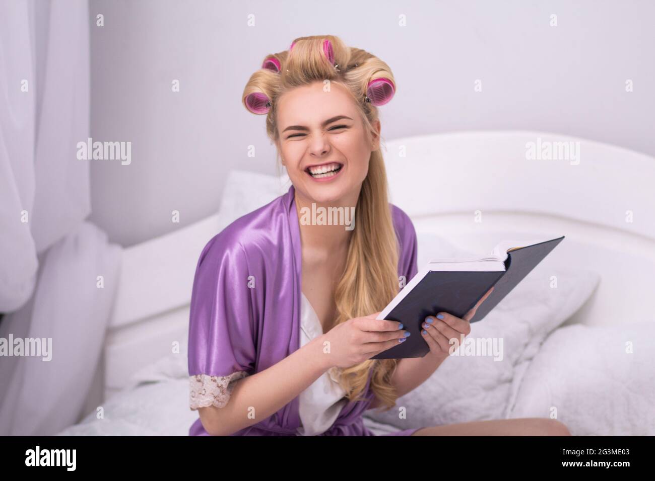 Lady reading book in bed Stock Photo - Alamy