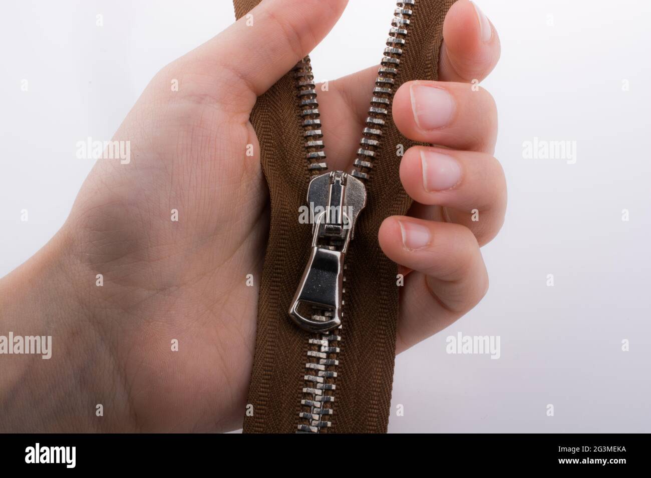 Hand holding zipper Stock Photo - Alamy