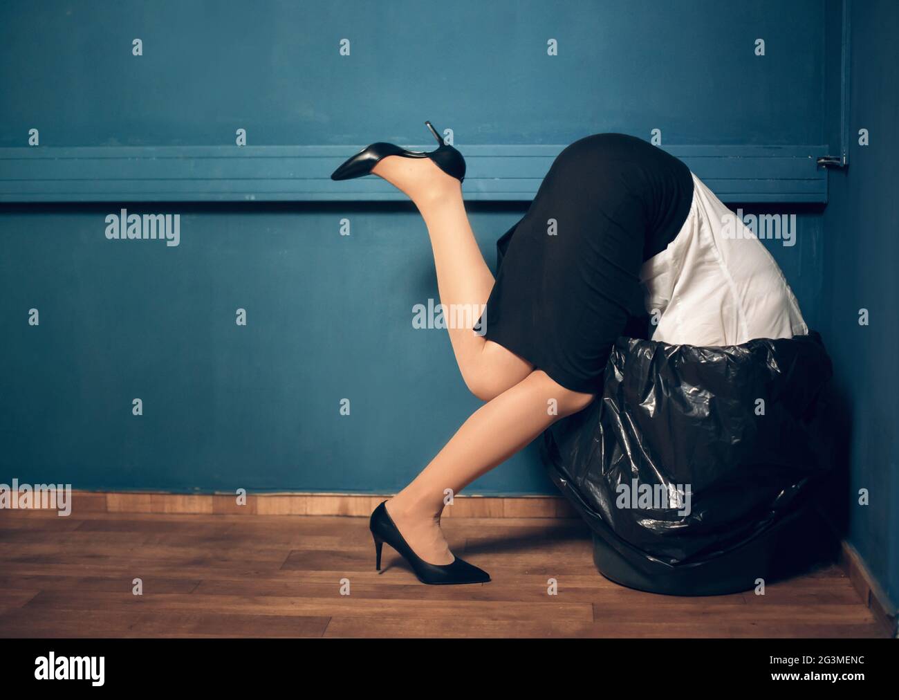 Woman with her head in garbage bin Stock Photo - Alamy