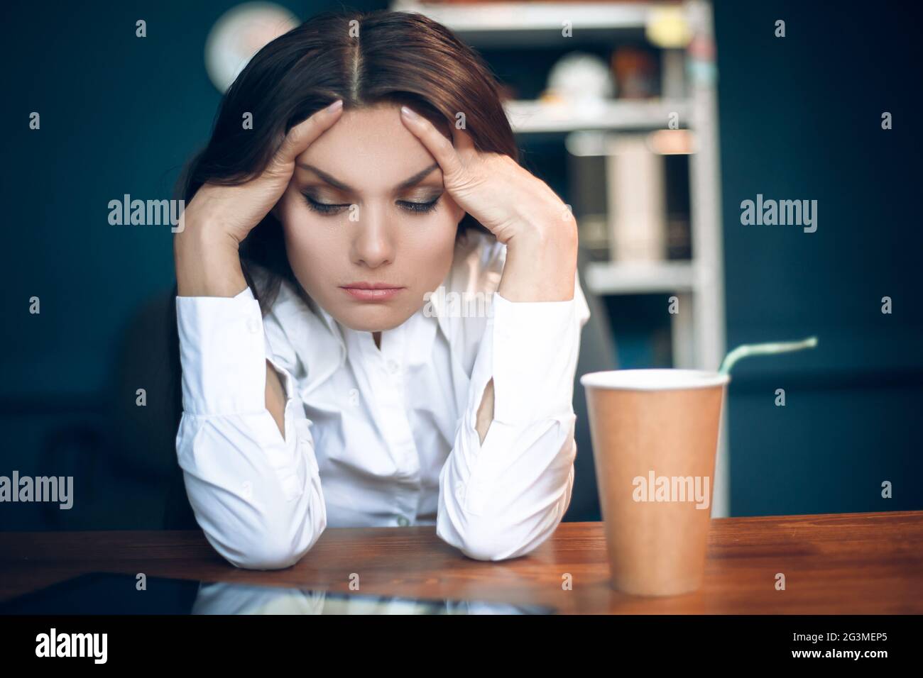 Bored woman alone in office Stock Photo - Alamy