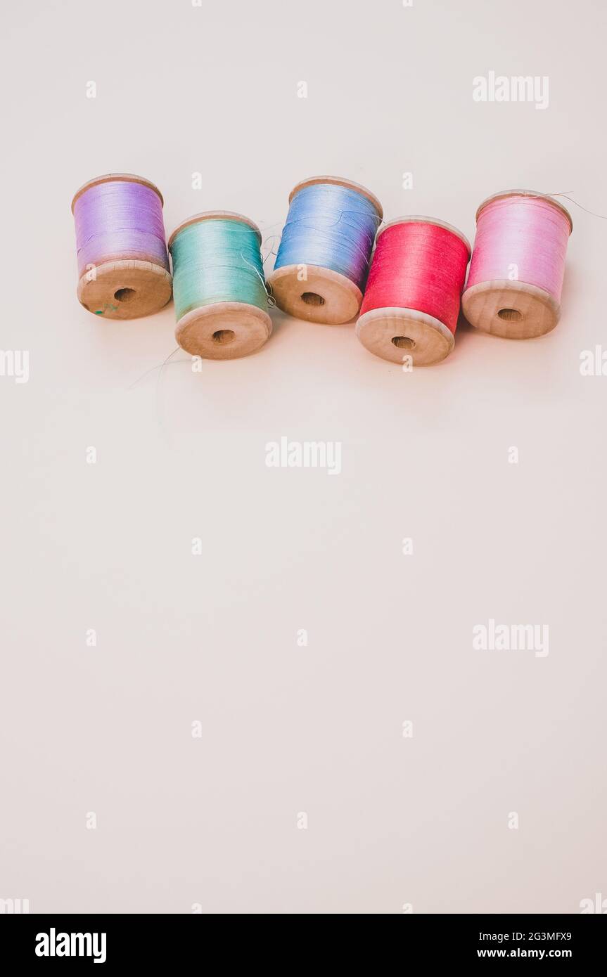 Colorful sewing threads on a light background with free space for text ...