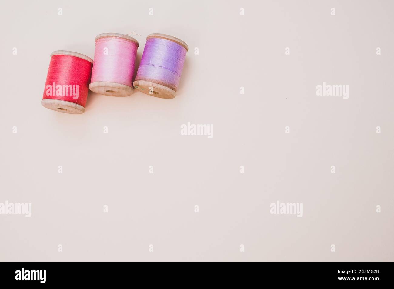 Colorful sewing threads on a light background with free space for text ...