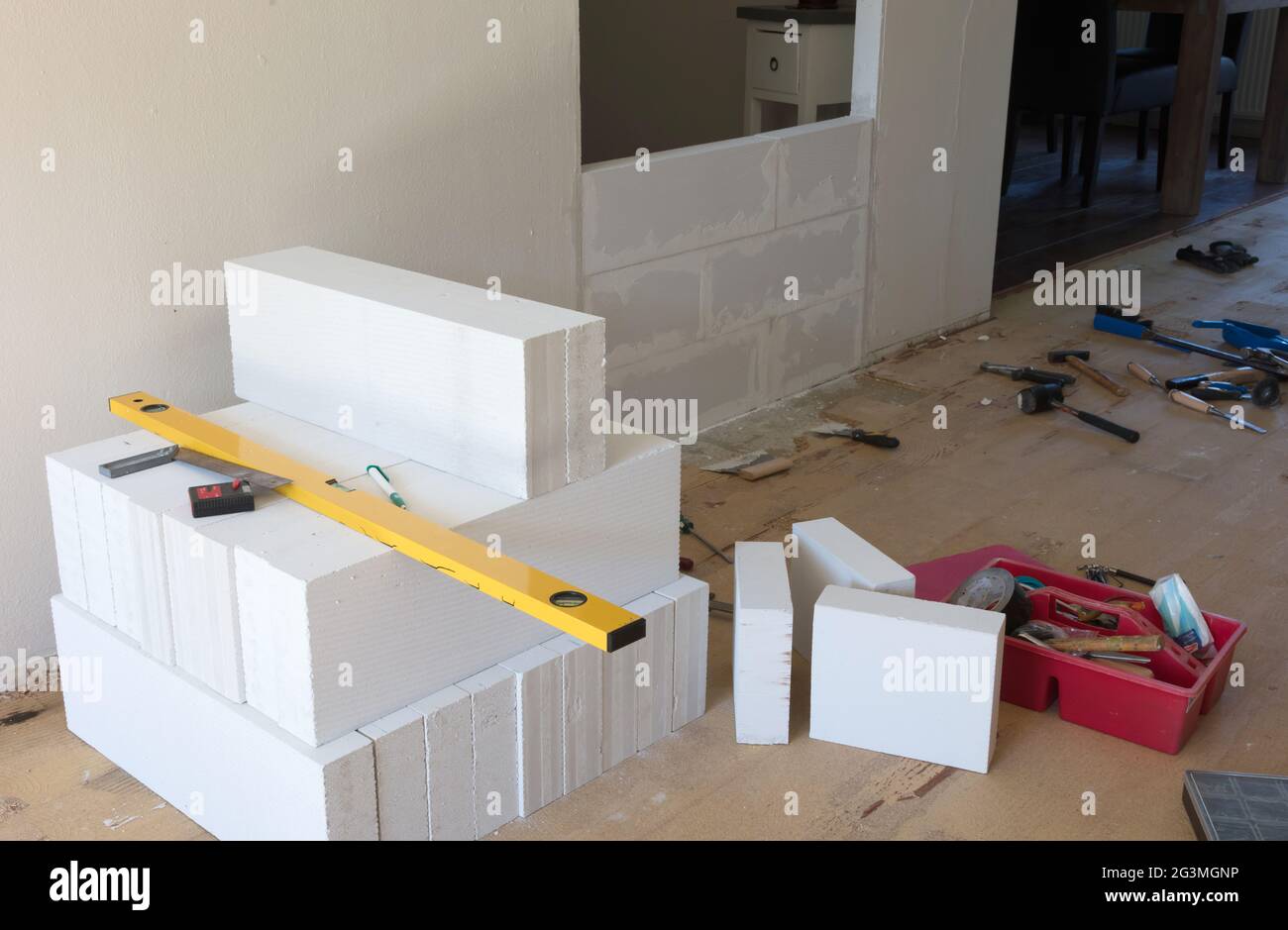 Building a small wall with lightweight concrete blocks Stock Photo - Alamy