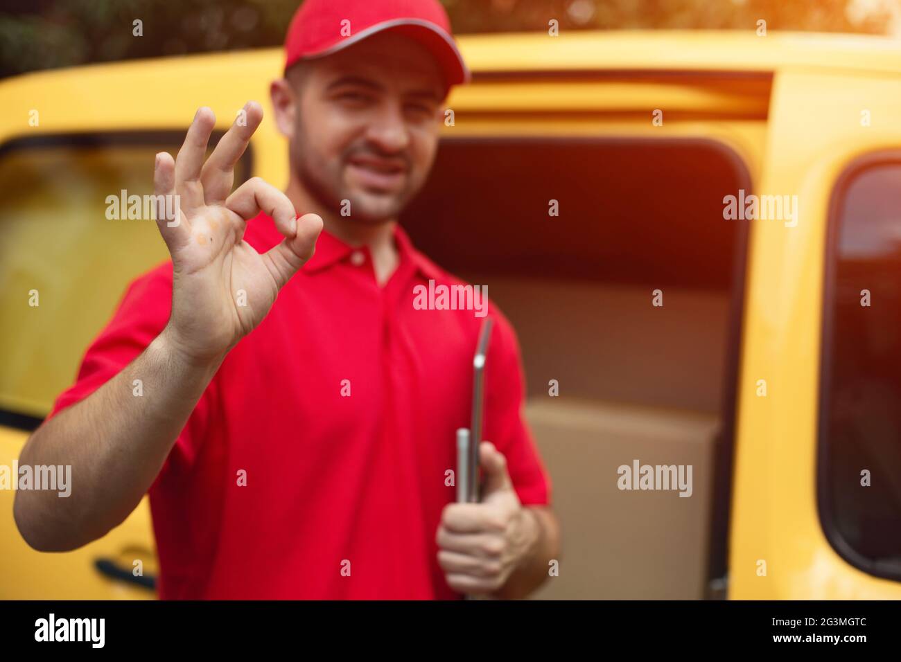 Confident positive delivery man hi-res stock photography and images - Alamy