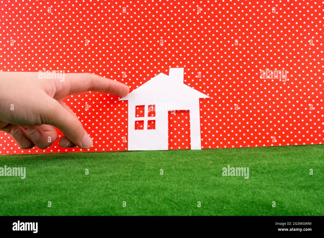 Hand pointing Paper house Stock Photo - Alamy