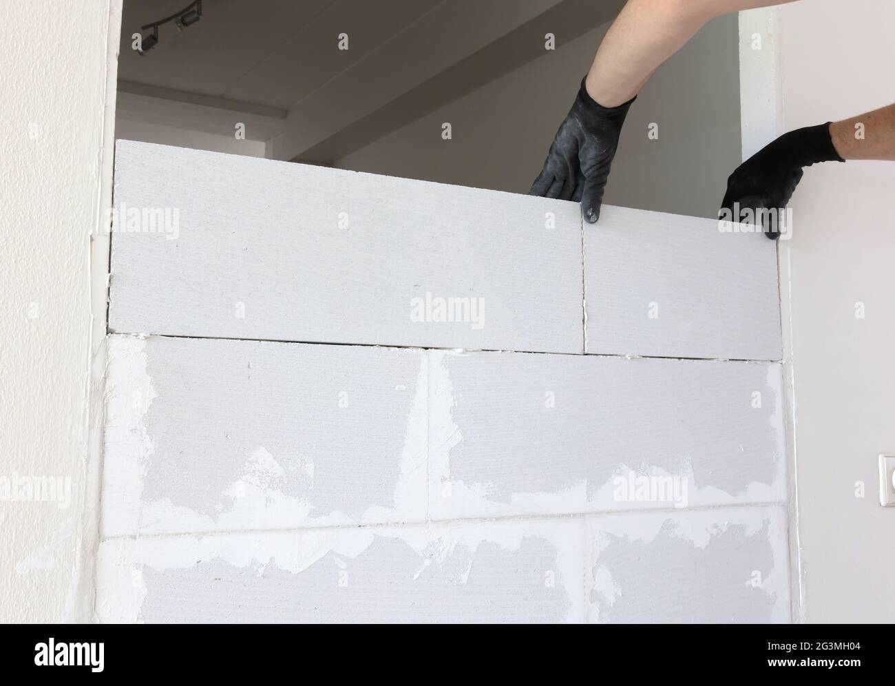 Building a small wall with lightweight concrete blocks Stock Photo - Alamy