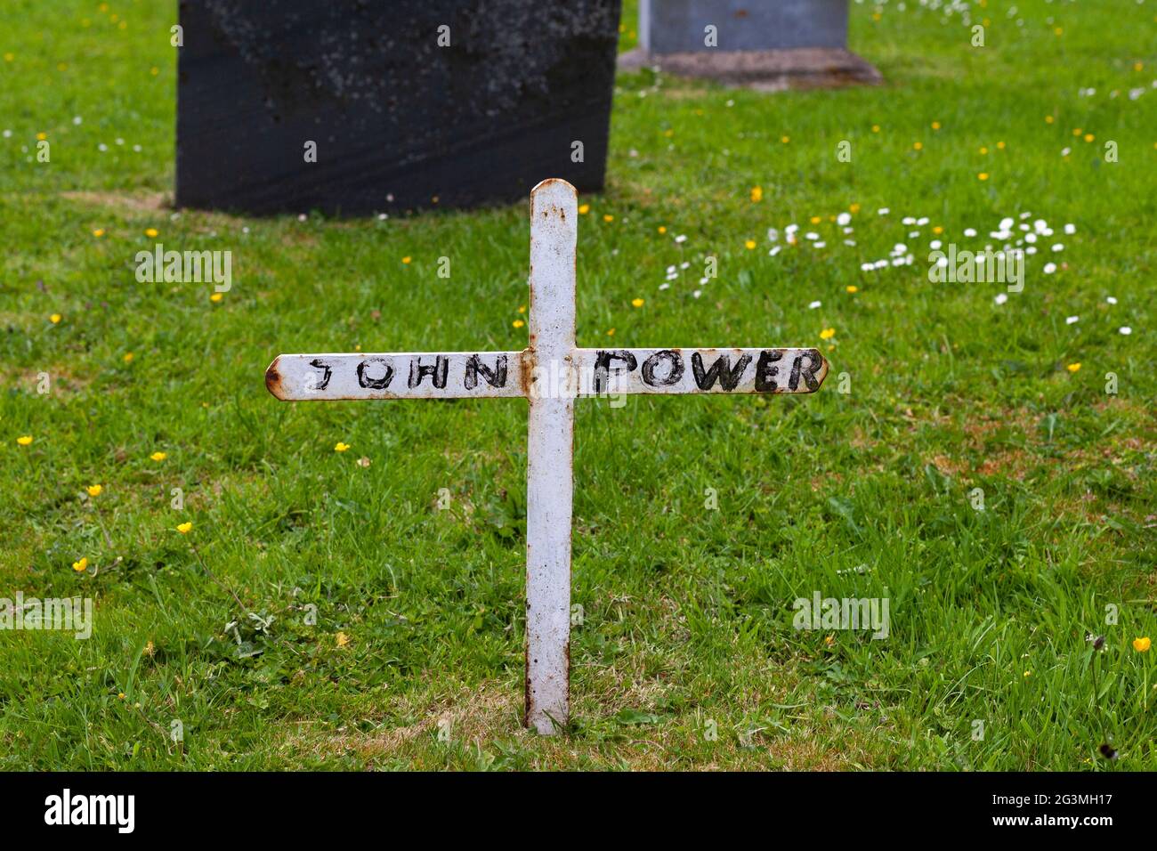 Small cross shaped grave marker in an Irish cemetery Stock Photo - Alamy