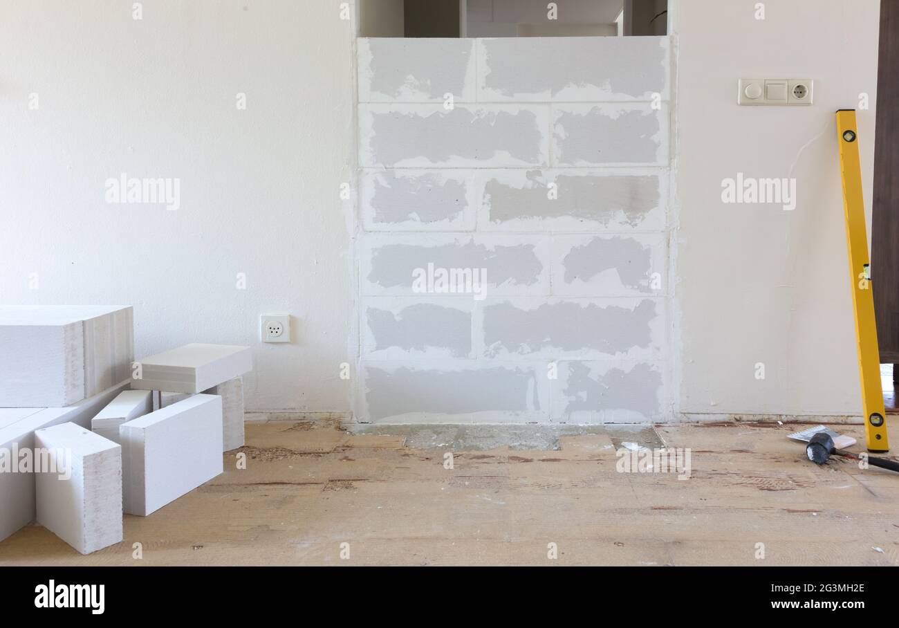 Building a small wall with lightweight concrete blocks Stock Photo - Alamy