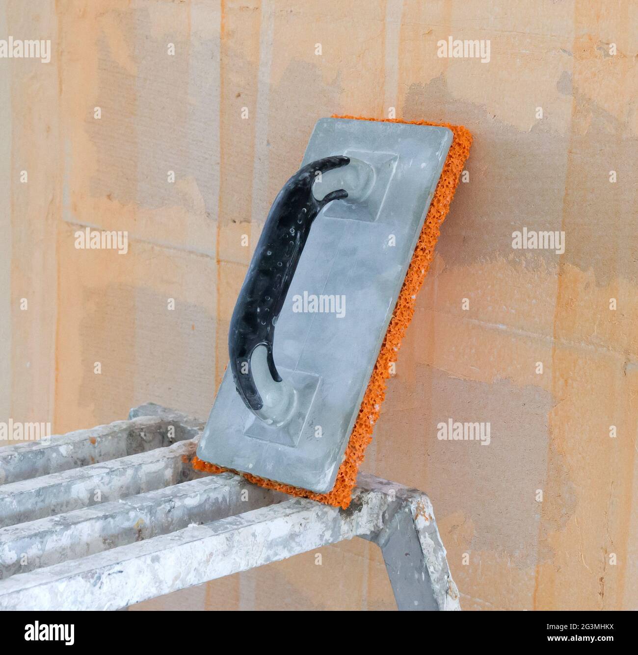 Small steps and a sponge used for plastering Stock Photo - Alamy