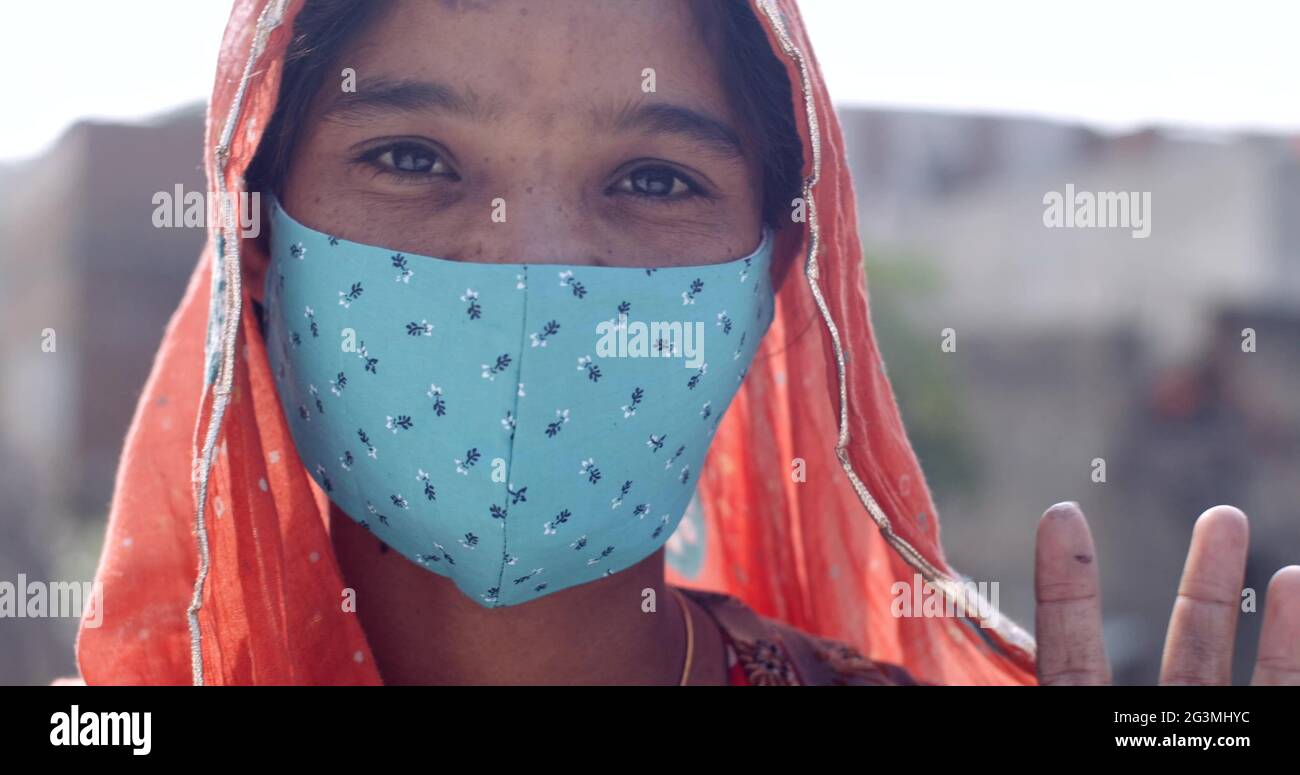 Young Indian female with smiling eyes is wearing a face mask Stock ...