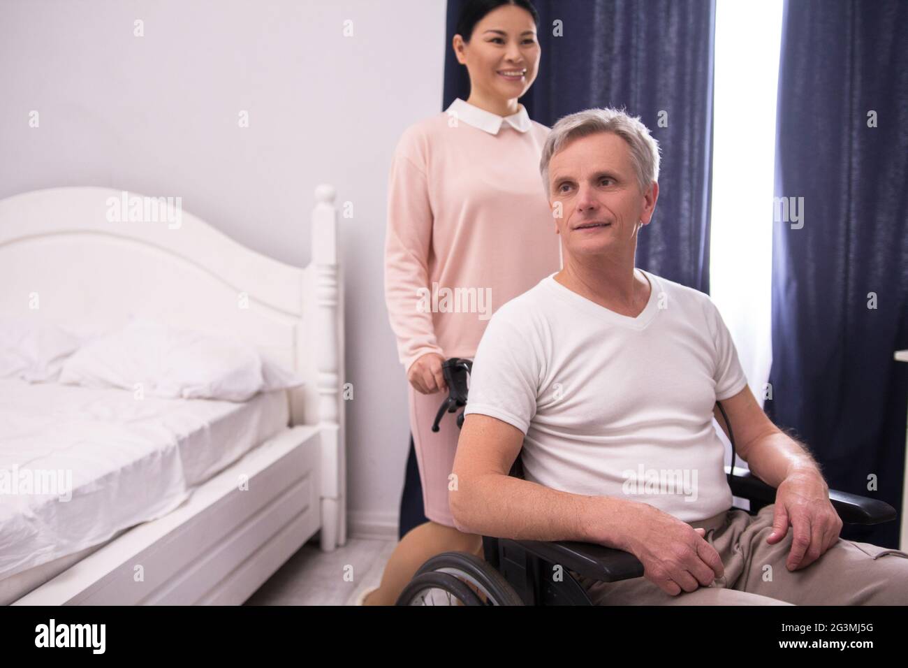 Nurse assisting disabled man Stock Photo - Alamy