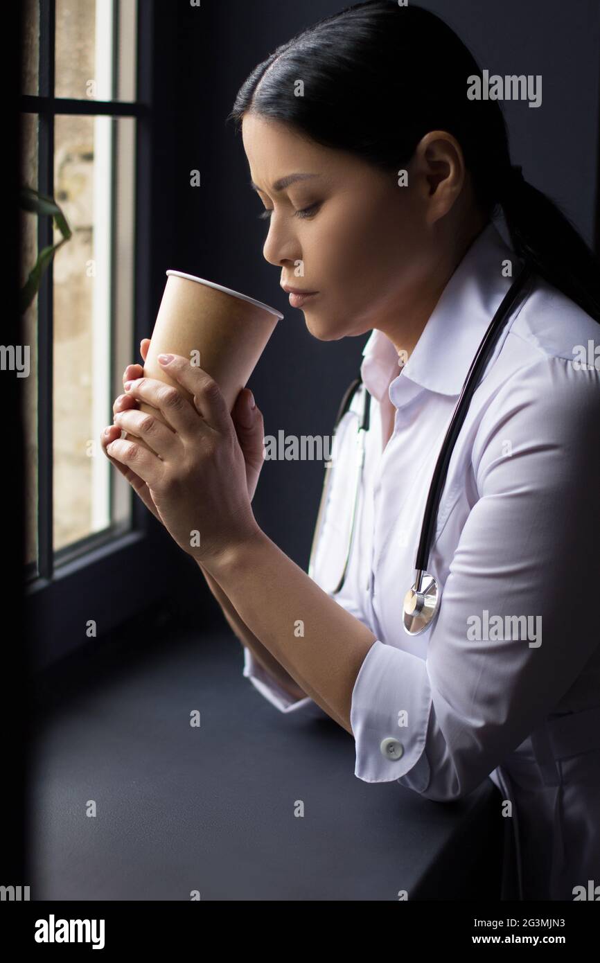 Nurse drinking coffee Stock Photo - Alamy