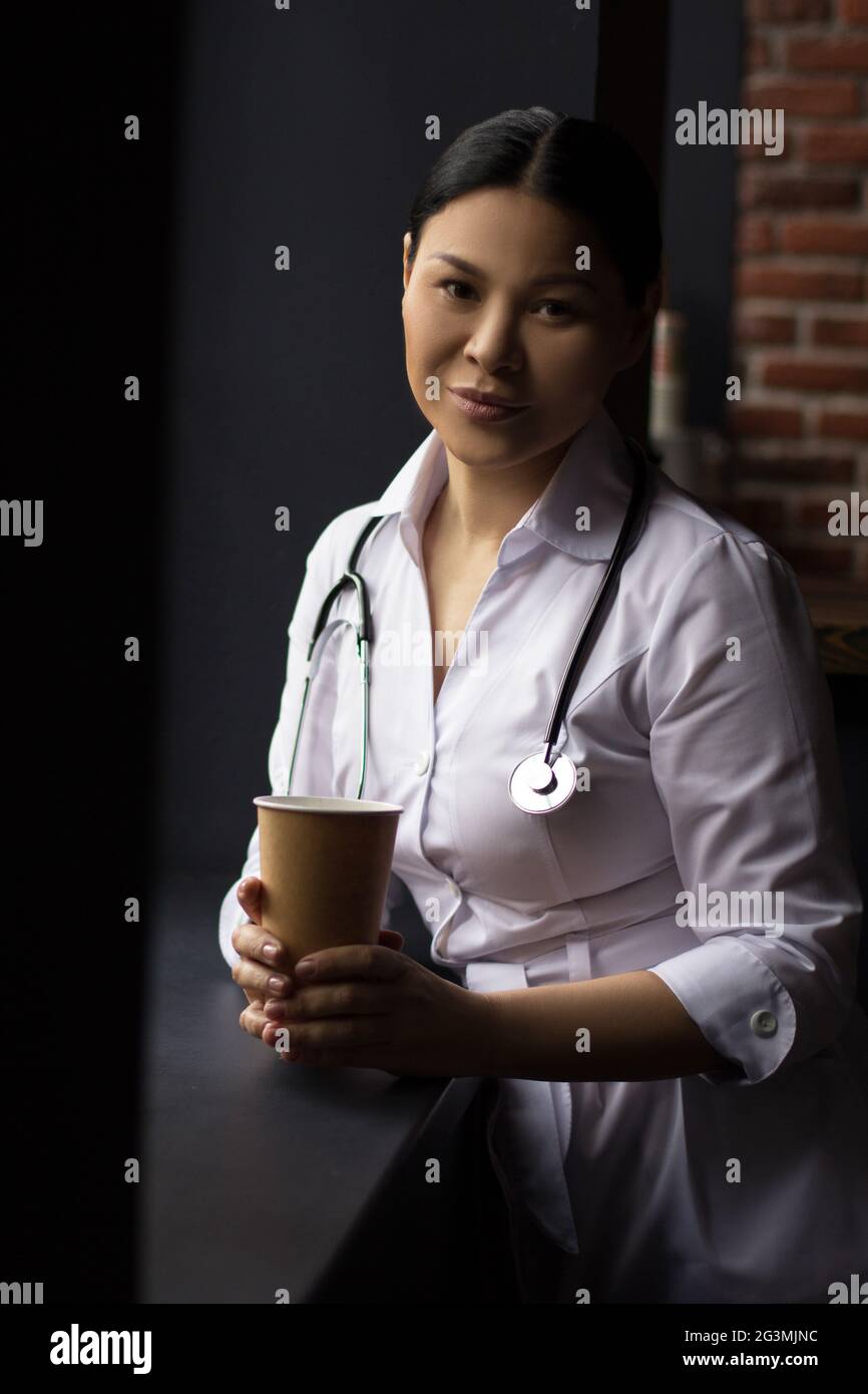 Nurse drinking coffee Stock Photo - Alamy
