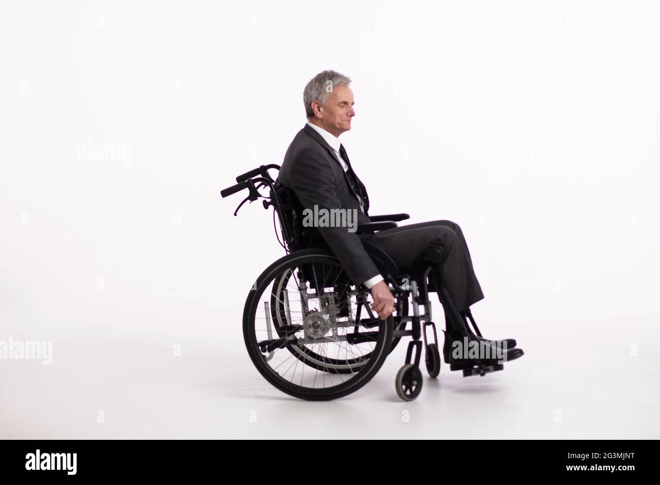 Disabled man in wheelchair in suit Stock Photo - Alamy