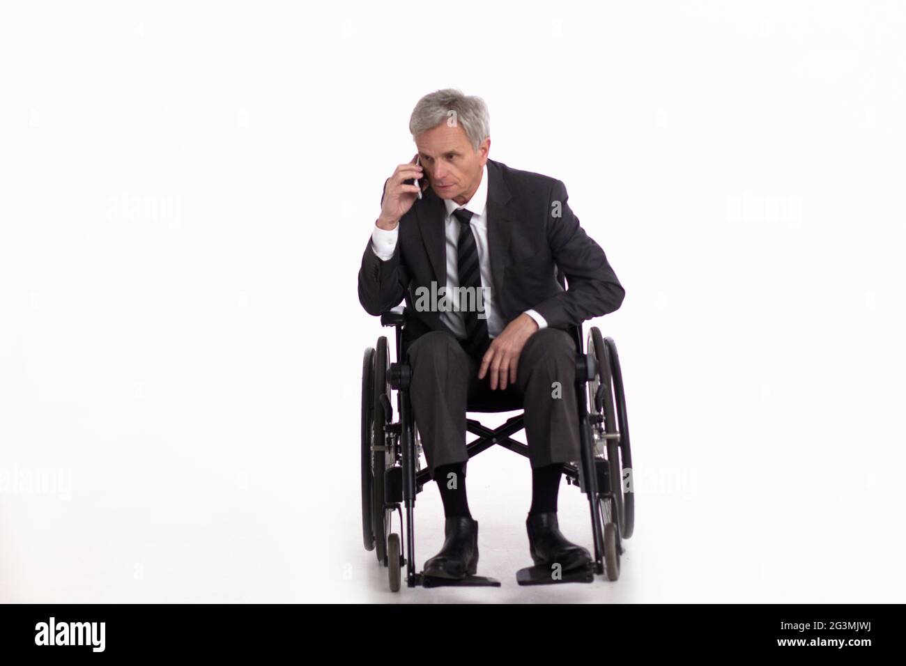 Disabled man in wheelchair in suit Stock Photo - Alamy