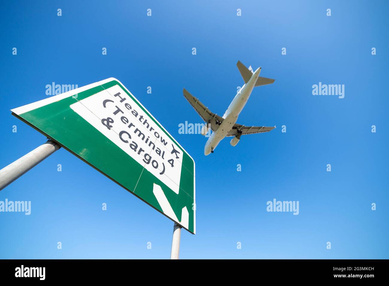 Plain white jet airliner plane landing at London Heathrow Airport in ...