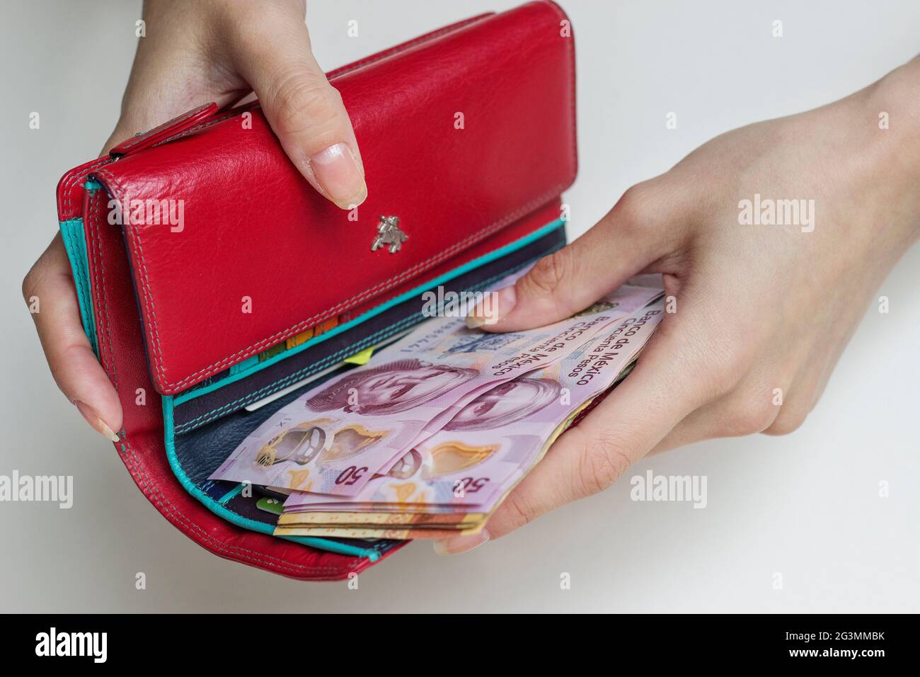 Mexico.Woman is taking pesos out of her wallet.Counting money Stock ...