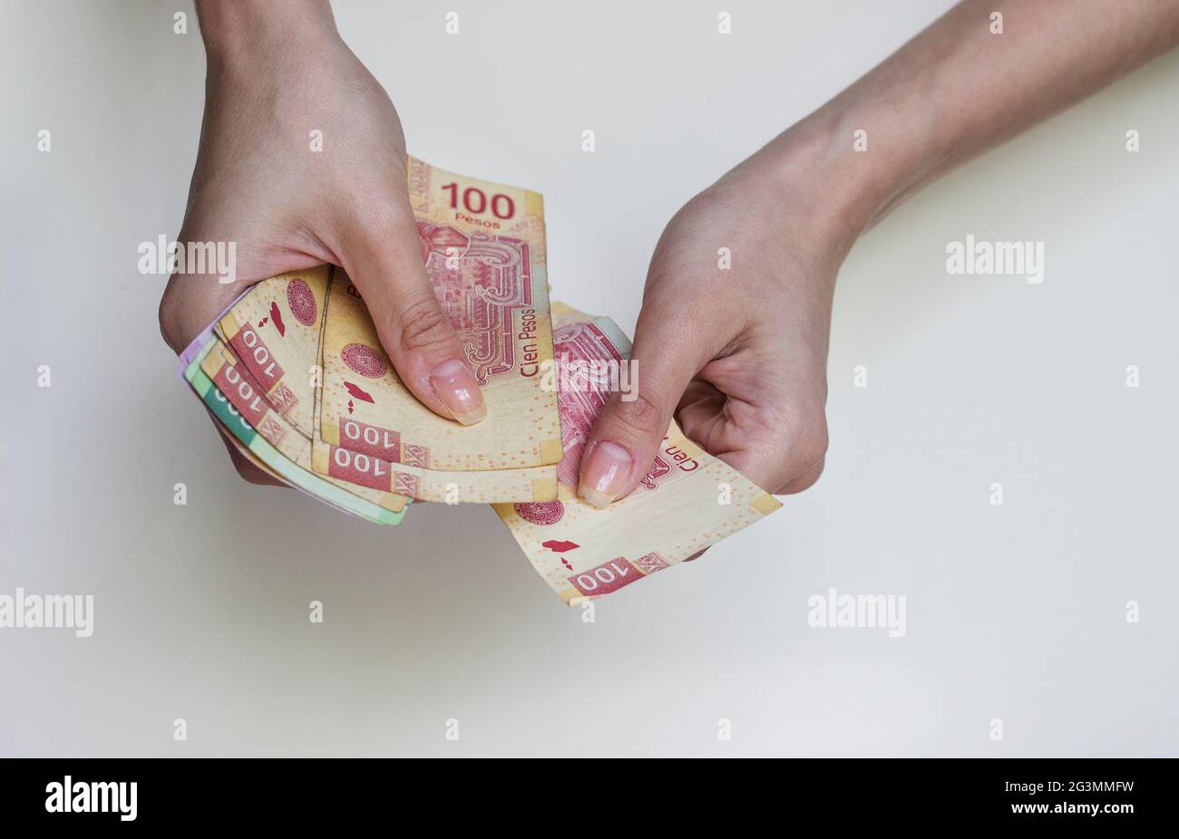Mexico.Woman is taking pesos out of her wallet.Counting money Stock ...