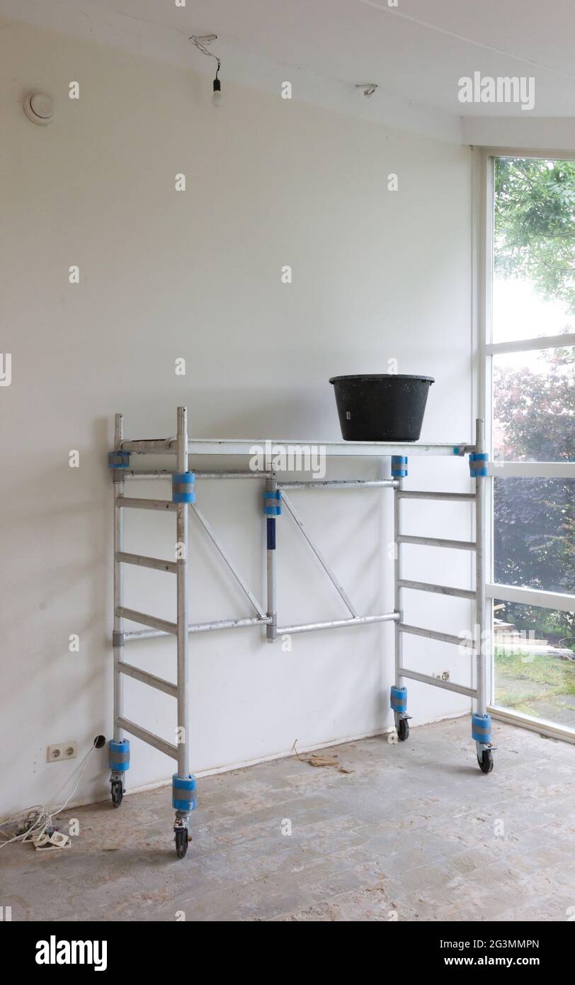 Worker tools - Bucket standing on rolling scaffolding Stock Photo - Alamy