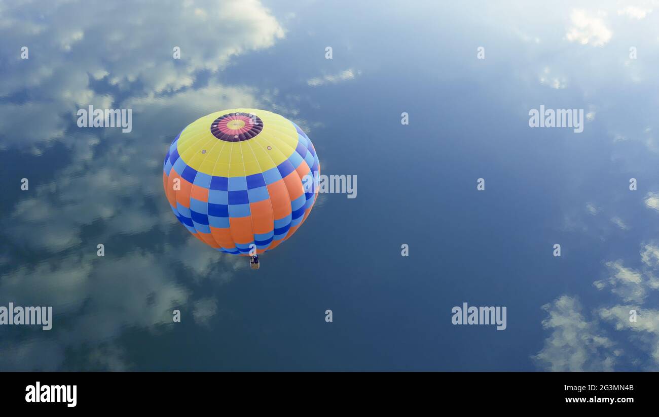 Yellow blue balloon over water. Top view Stock Photo - Alamy